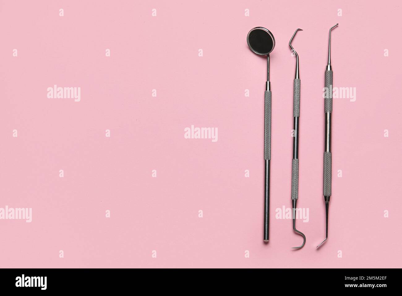 Dental tools on pink background Stock Photo - Alamy