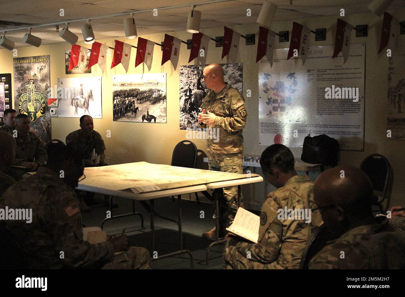 Maj. Gen. Richard R. Coffman (standing) speaks to the leaders and staff ...