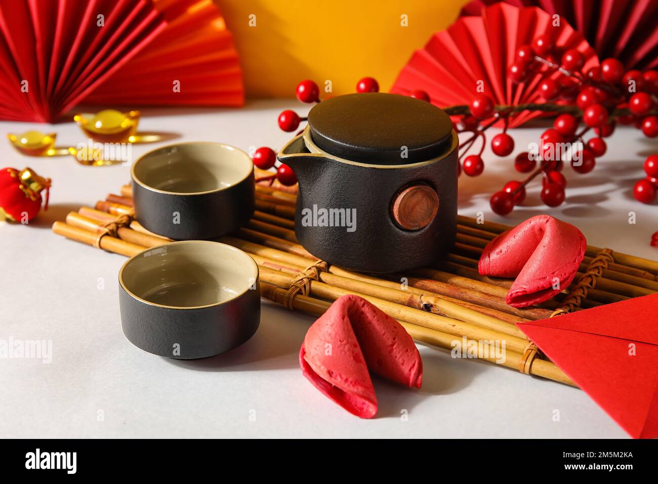 Fortune cookies with teapot, cups and Chinese symbols on table near ...