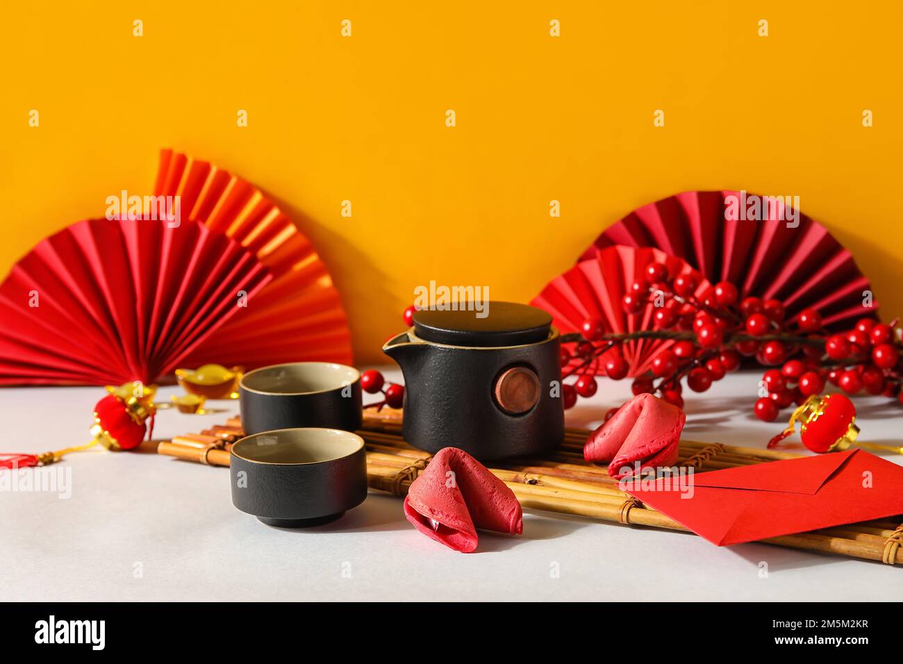 Fortune cookies with teapot, cups and Chinese symbols on table near ...