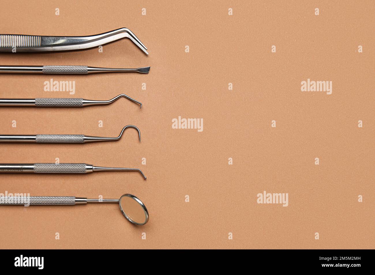 Dental tools on brown background Stock Photo - Alamy