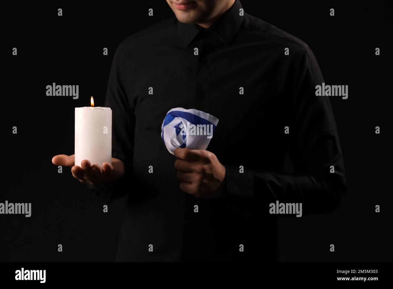 Jewish man with candle and flag of Israel on dark background ...