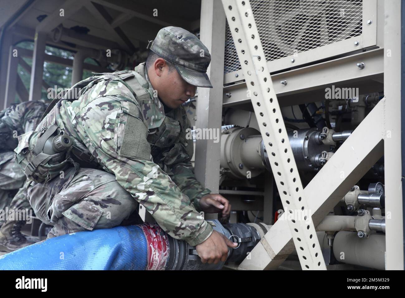 Spc. Merlin Padilla, a water treatment specialist assigned to Alpha ...
