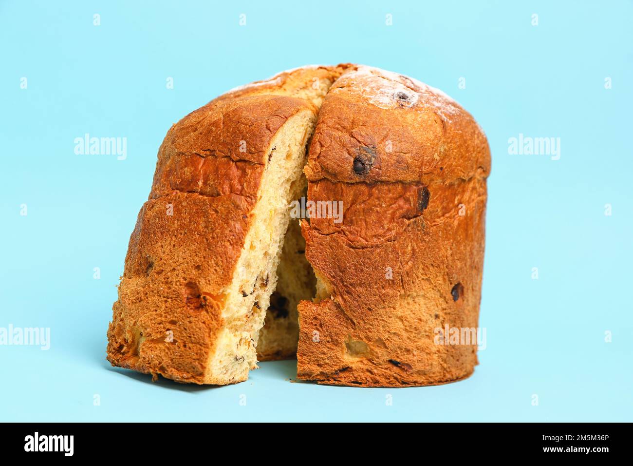 Cut Panettone on blue background Stock Photo - Alamy