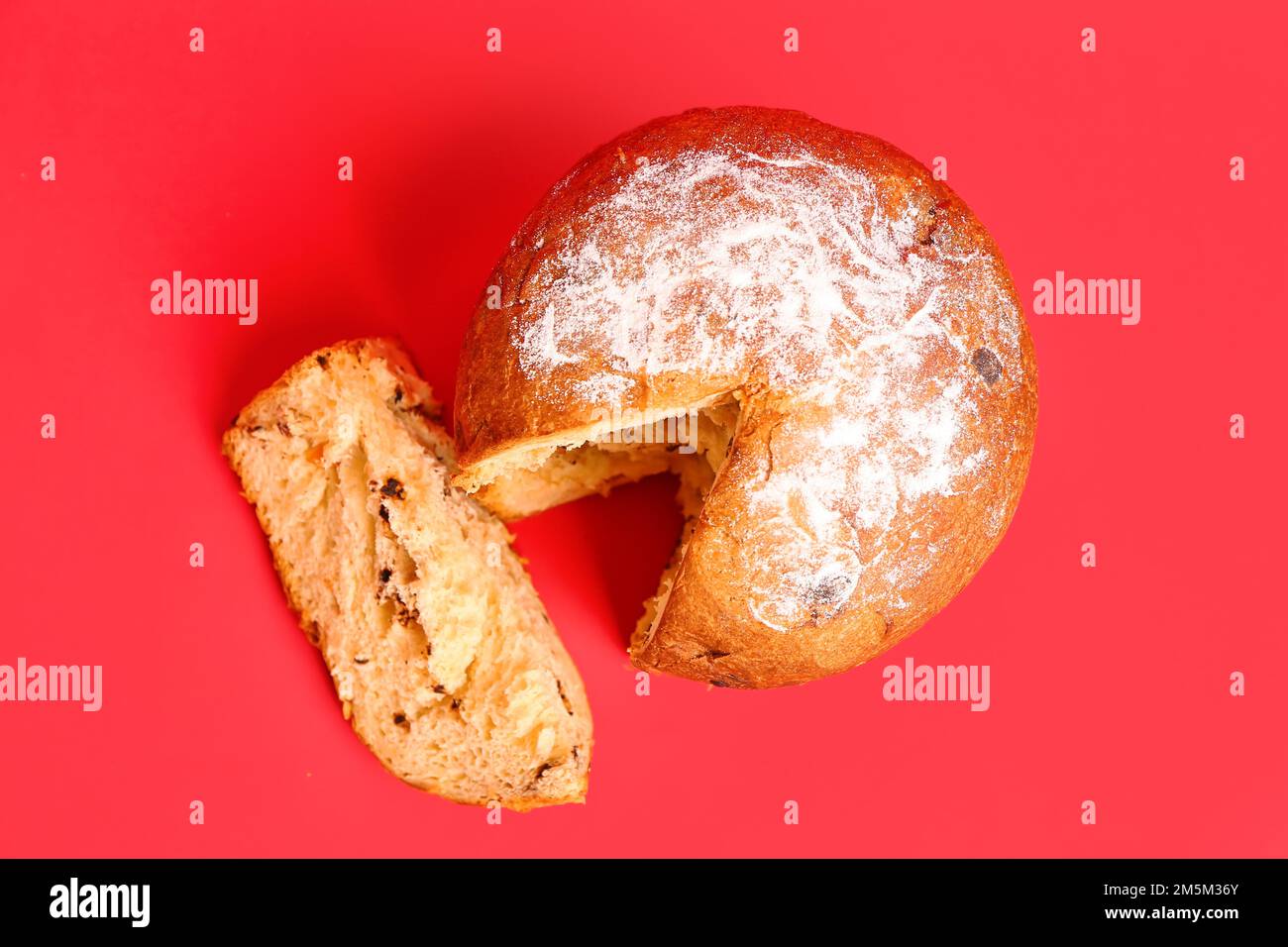 Cut Panettone on red background, top view Stock Photo - Alamy