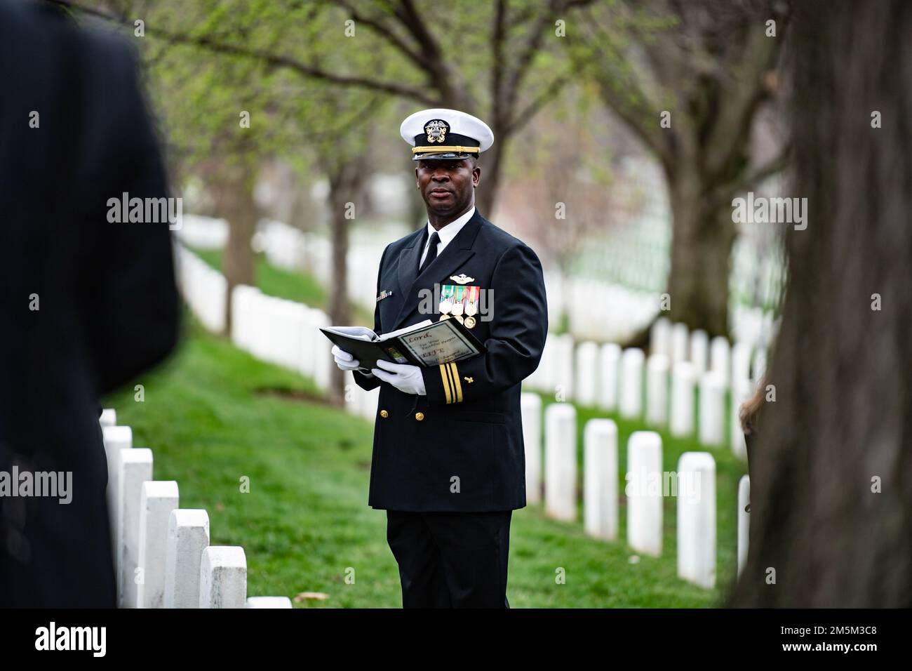 A U.S. Navy Chaplain gives remarks during military funeral honors with ...