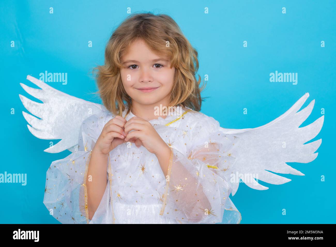 Kid wearing angel costume white dress and feather wings. Innocent child ...