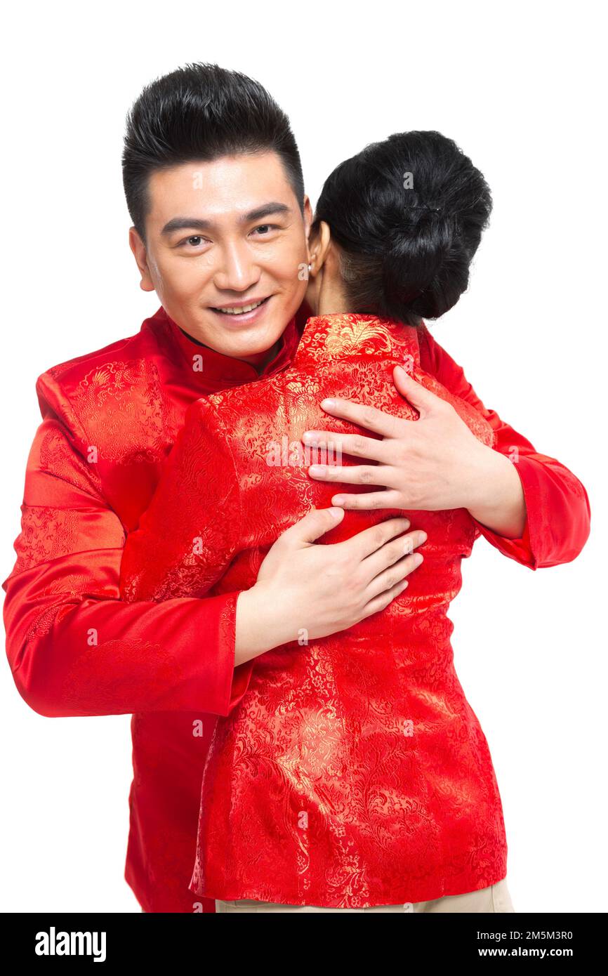 Chinese New Year tang suit man hug mother Stock Photo - Alamy