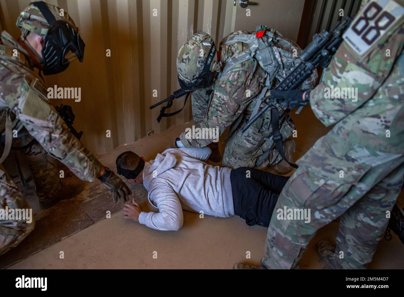 Three Best Warrior competitors detain a high-value target (HVT) during ...