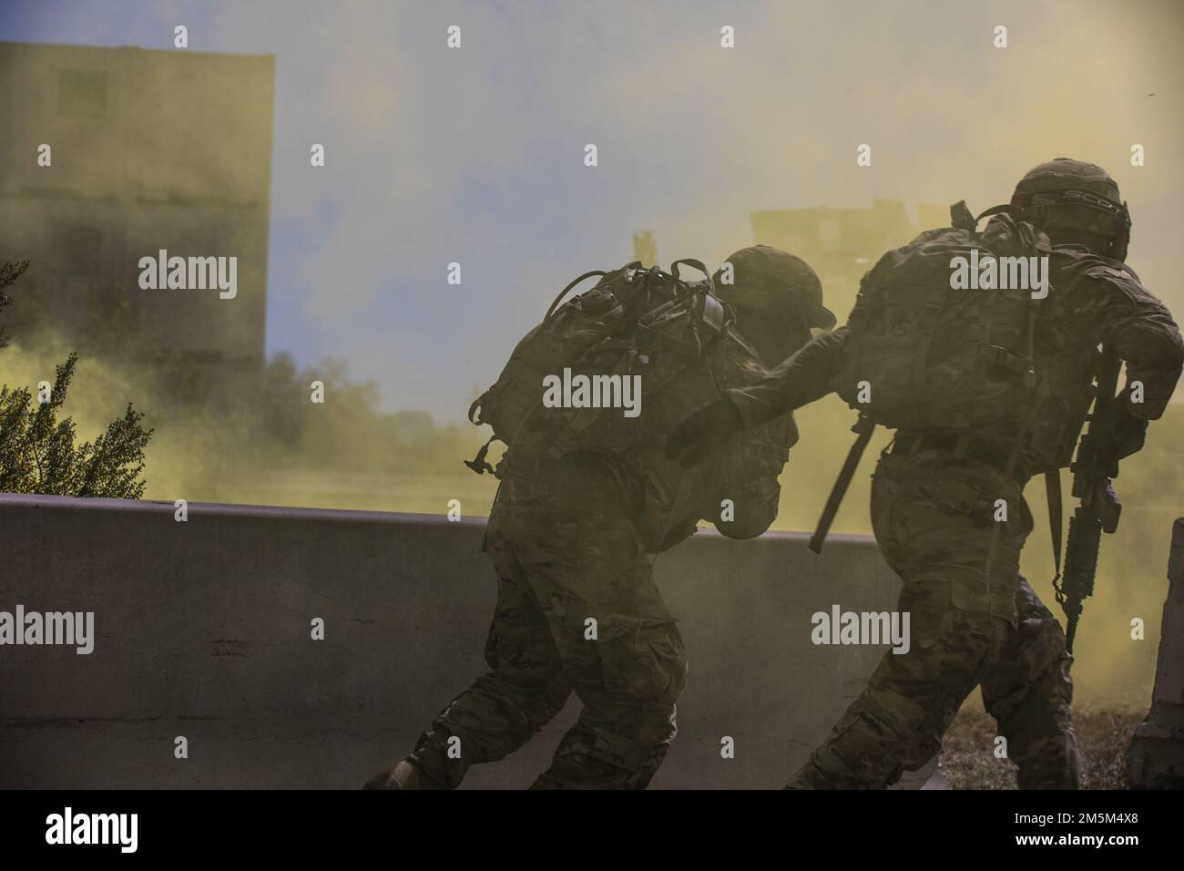 Two Best Warrior competitors run toward a mine-resistant ambush ...