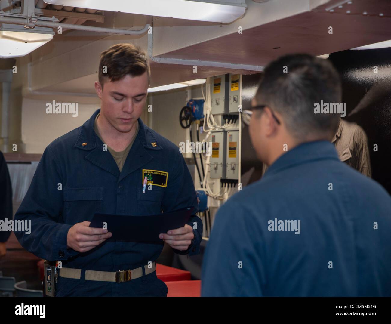 OKINAWA, Japan (March 24, 2022) Ensign Dylan Warner (left), from Palm ...