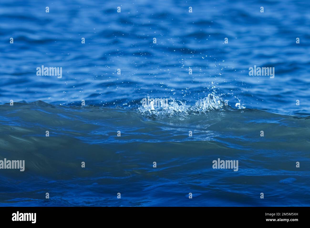 Ocean wave splashing Stock Photo - Alamy