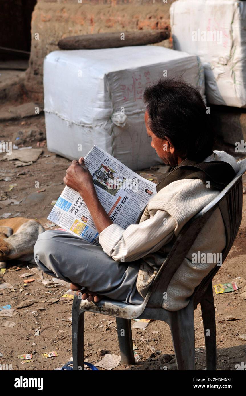 A Bengali man reading the morning newspaper in Kolkata, India Stock ...