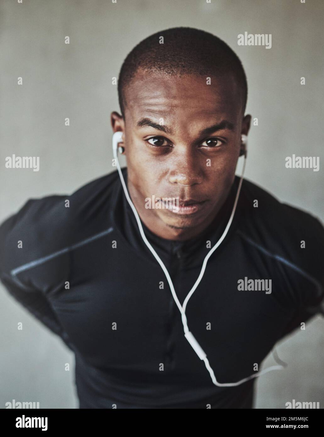 Get fit to the pace of your own beat. Portrait of a sporty young man ...