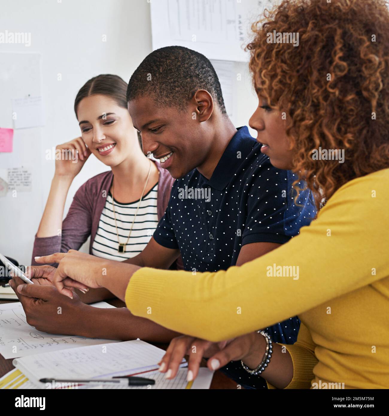 Collecting ideas online. a group of colleagues having a meeting in a ...