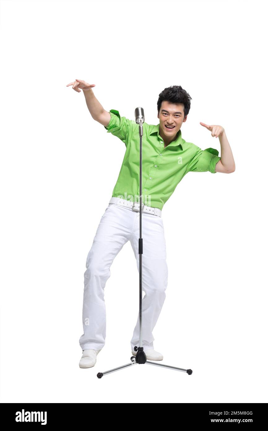 Man singing while holding a microphone Cut Out Stock Images & Pictures - Alamy