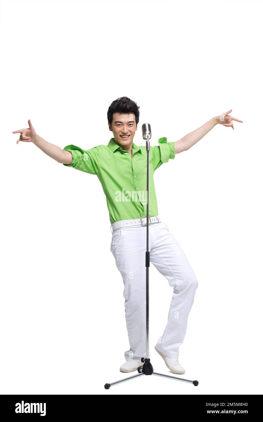 Man singing while holding a microphone Cut Out Stock Images & Pictures - Alamy