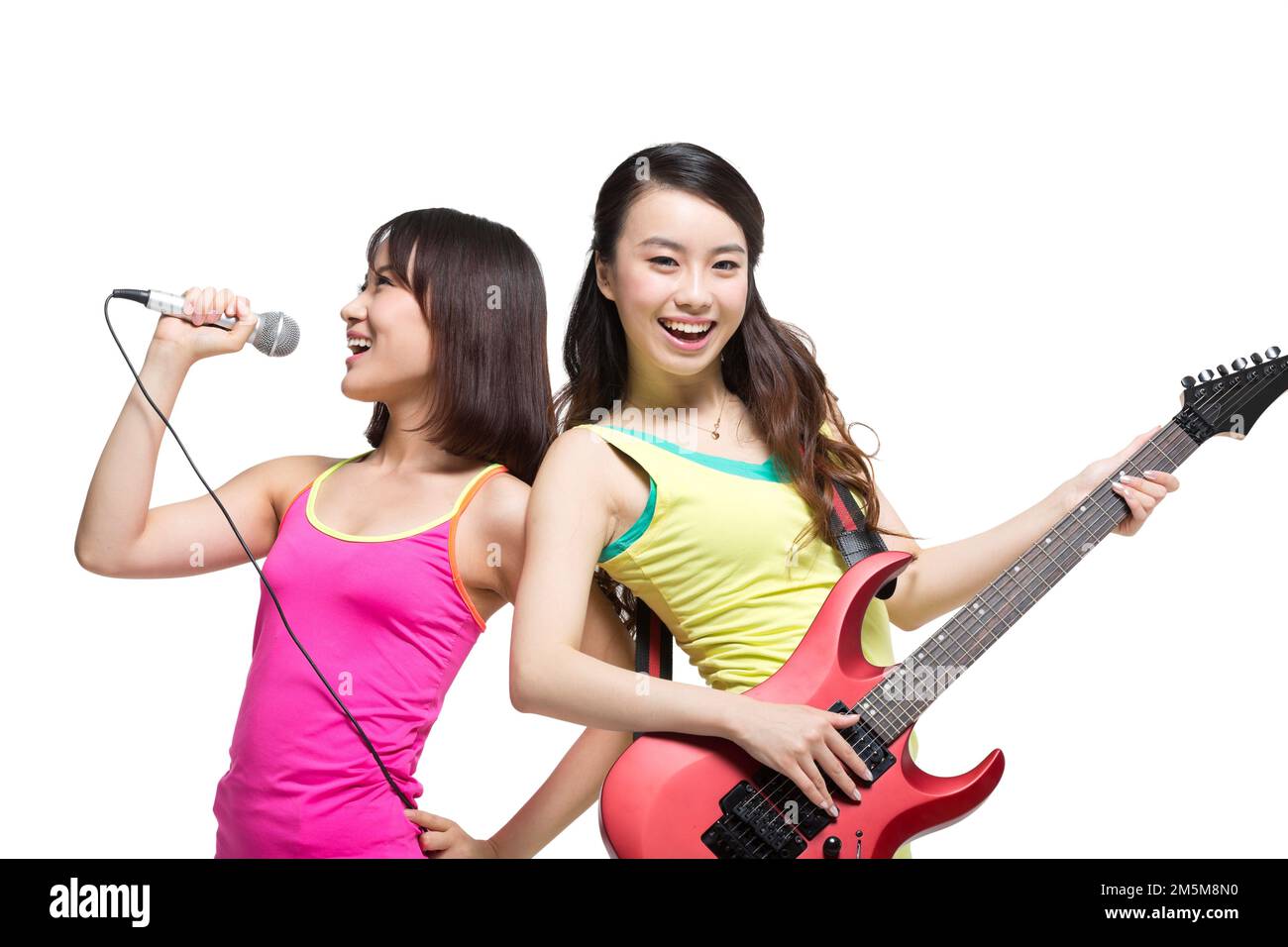 Fashion dynamic young people play the guitar singing Stock Photo - Alamy