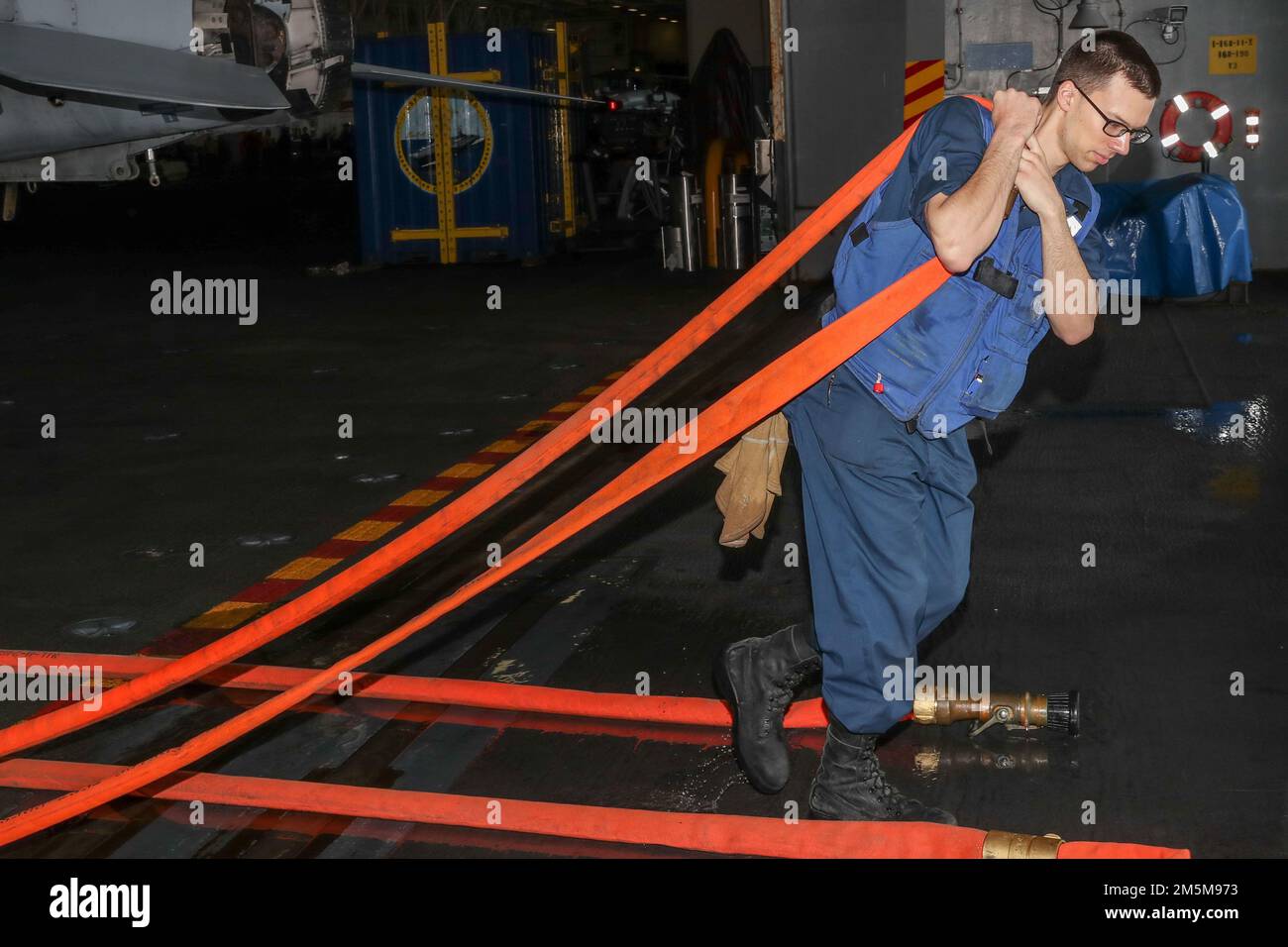 Damage Controlman Fireman Ethan Voss, from Abilene, Texas, assigned to ...
