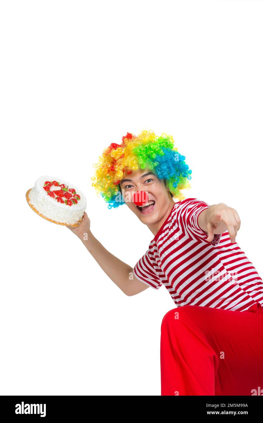 Shed happy funny clown, with cake Stock Photo - Alamy