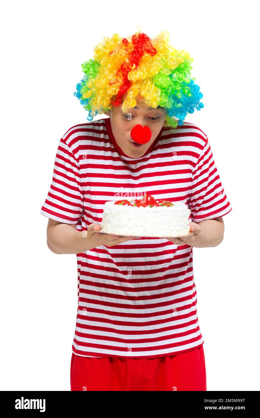 Shed happy funny clown, with cake Stock Photo - Alamy