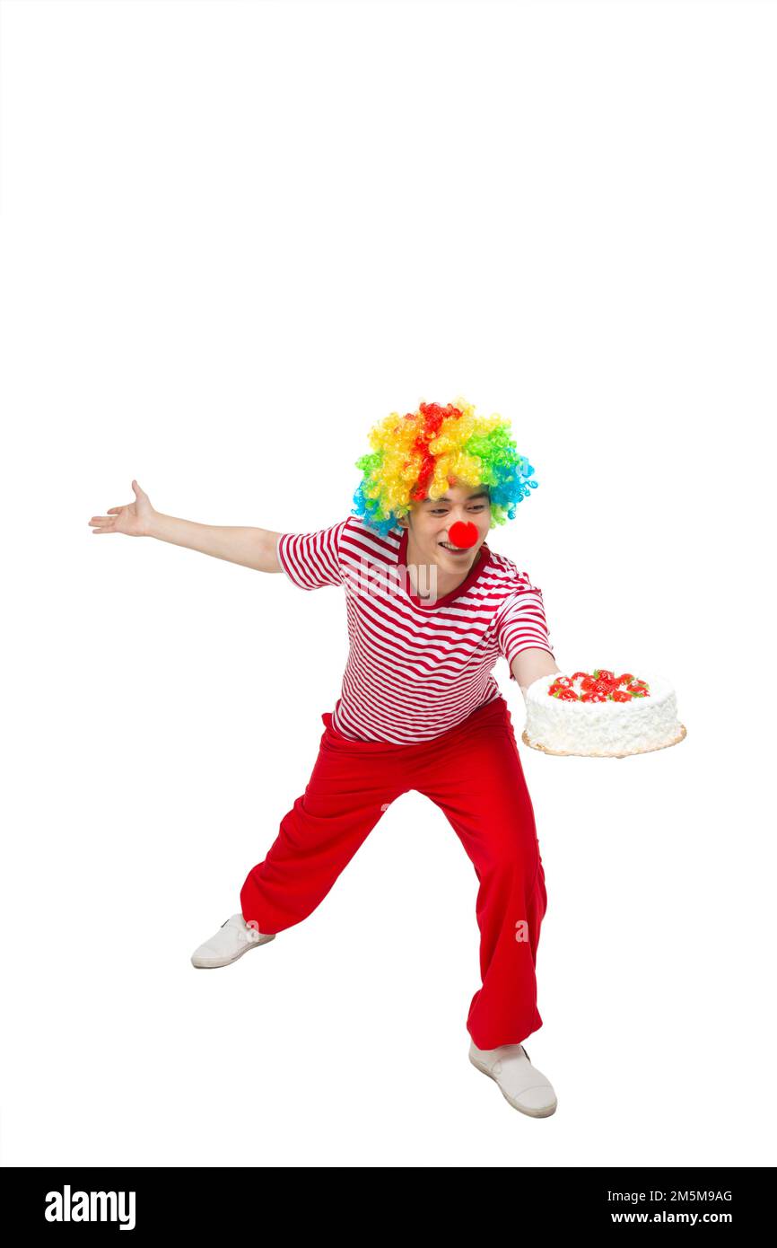 Shed happy funny clown, with cake Stock Photo - Alamy