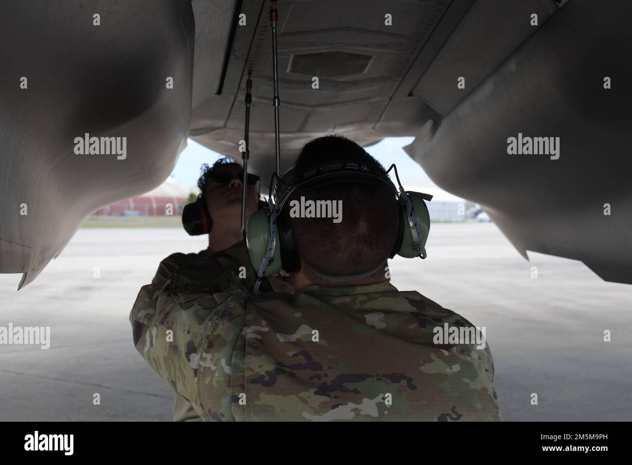 U.S. Air Force Senior Airman Stephan York, back, and Staff Sgt. Brock ...
