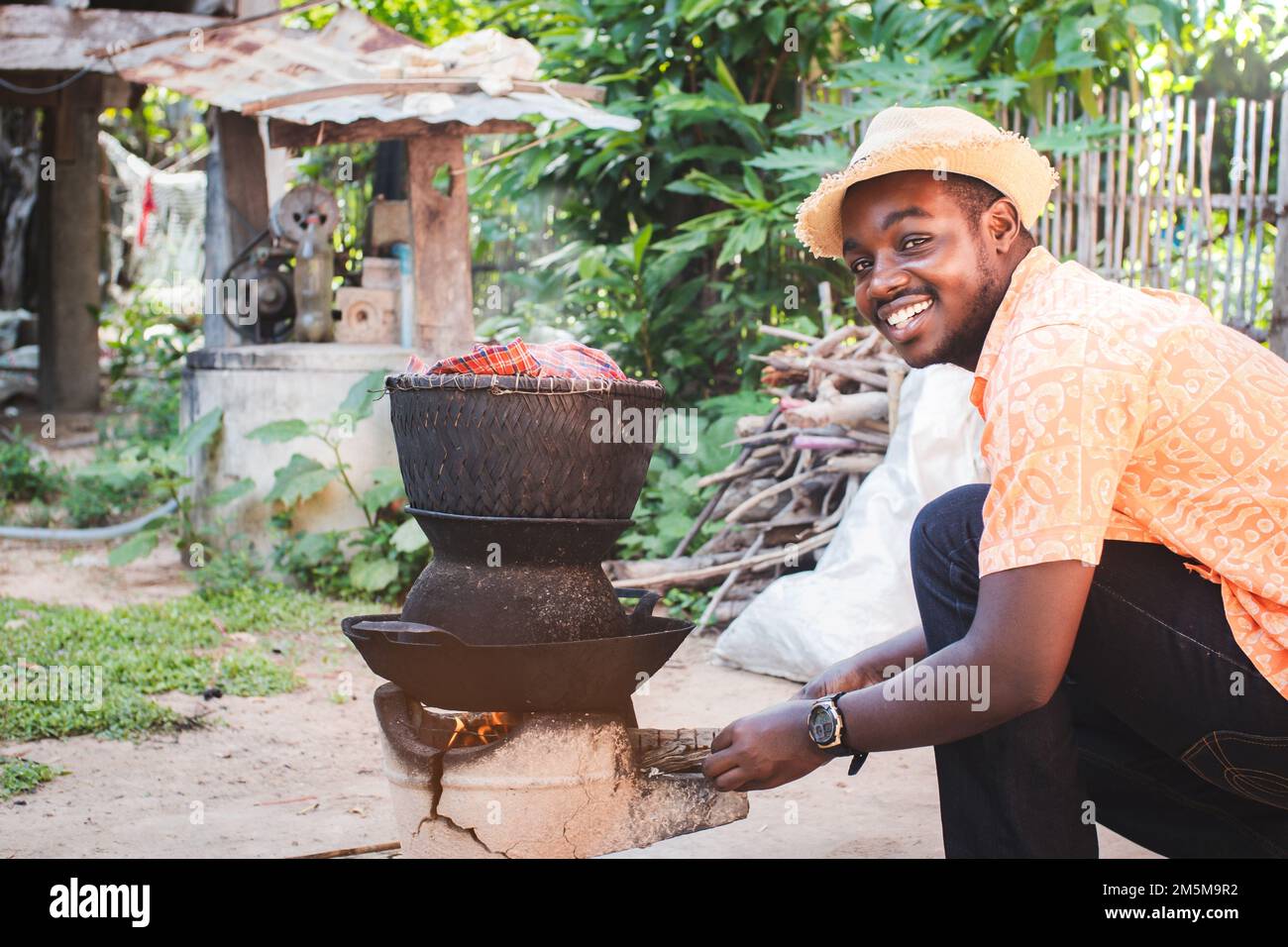 African villager cooking lunch in a rural district on the outskirts of ...