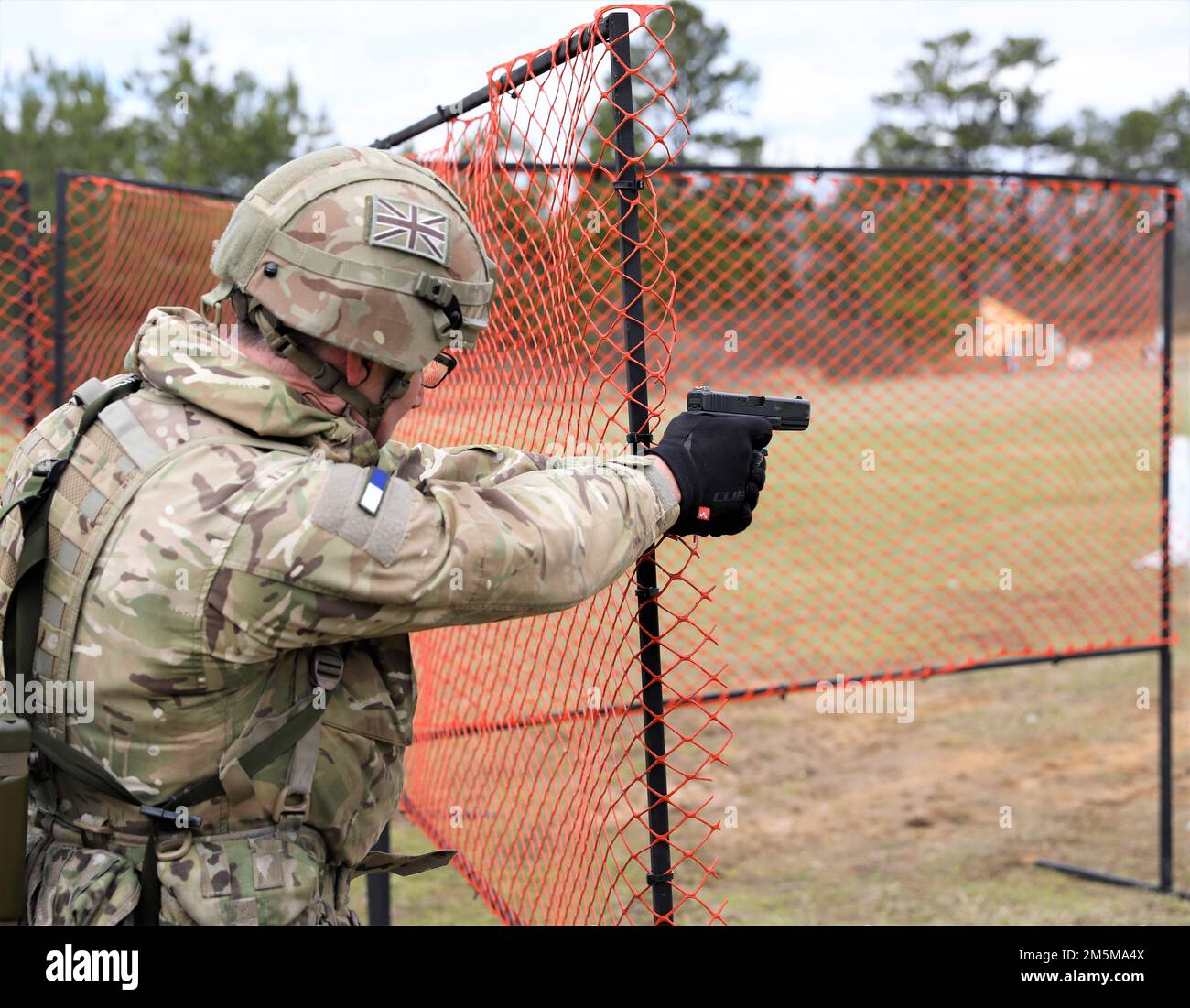 A British service member runs a shooting lane during the AFSAM/WPW ...