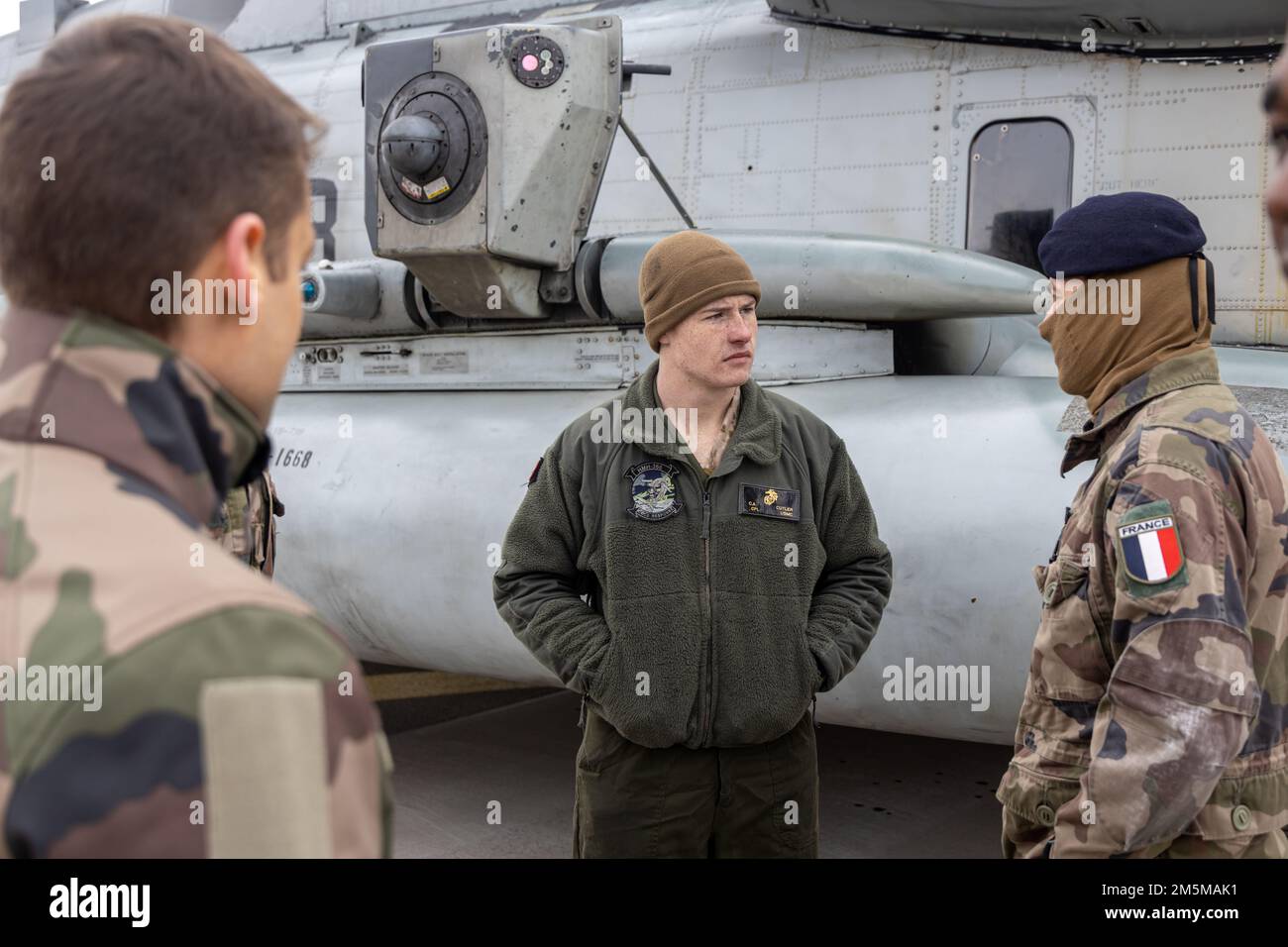 U.S. Marine Corps Cpl. Chant Cutler speaks with French service members ...