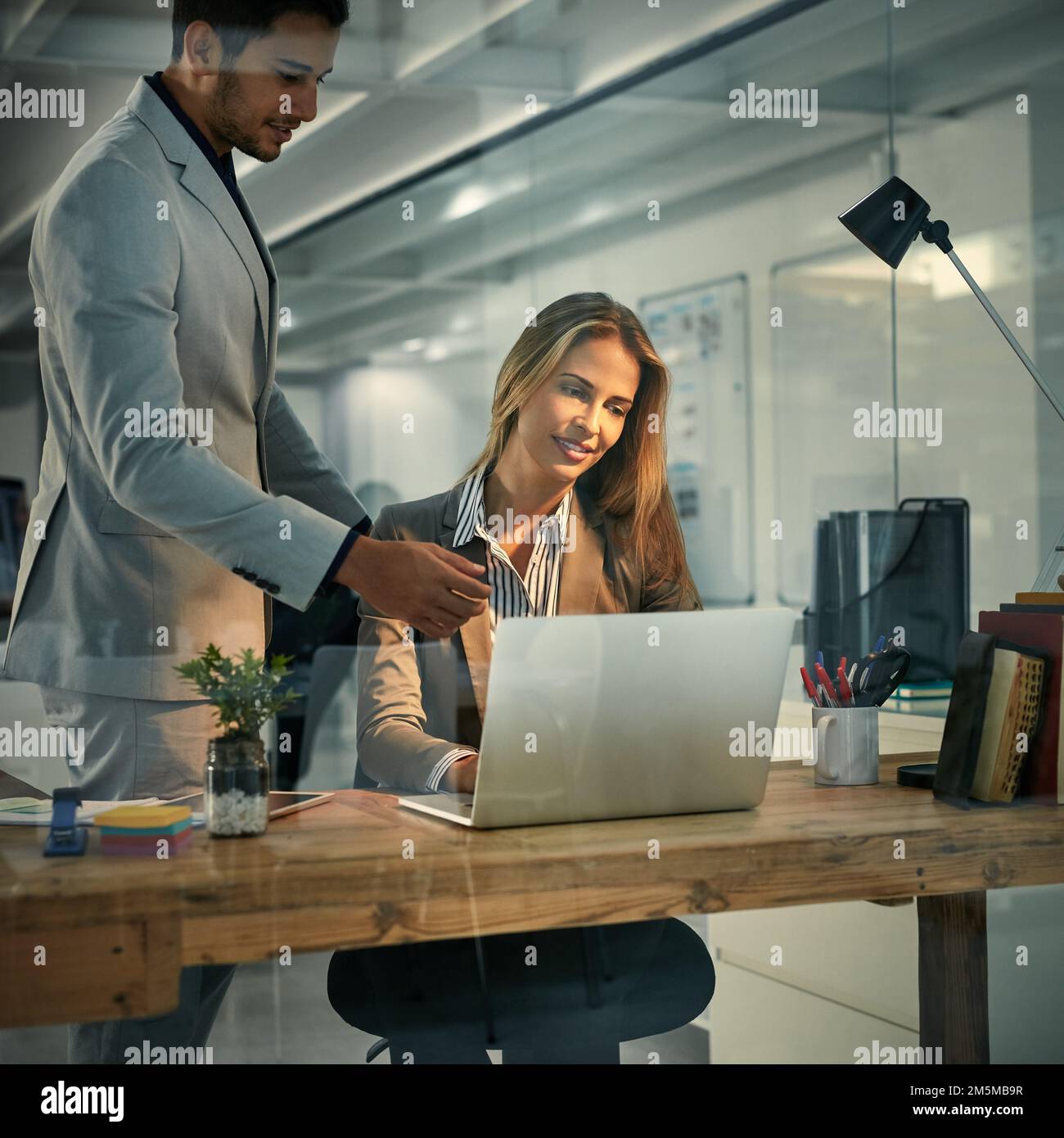 They know the value of overtime. colleagues using a laptop together on ...