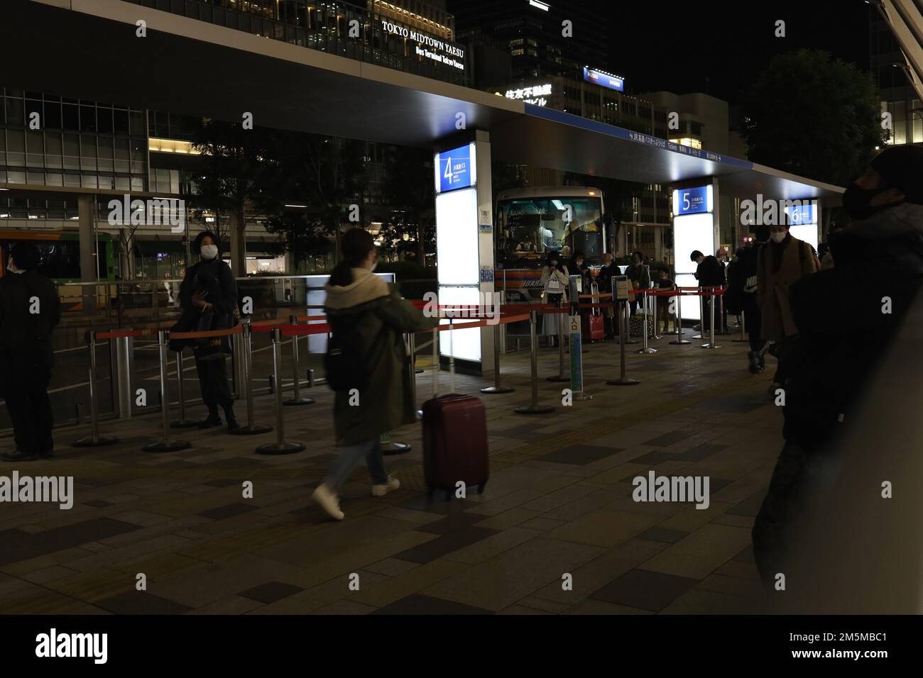 Chiyoda Ward, Tokyo, Japan, December 2022.People waiting for a highway ...