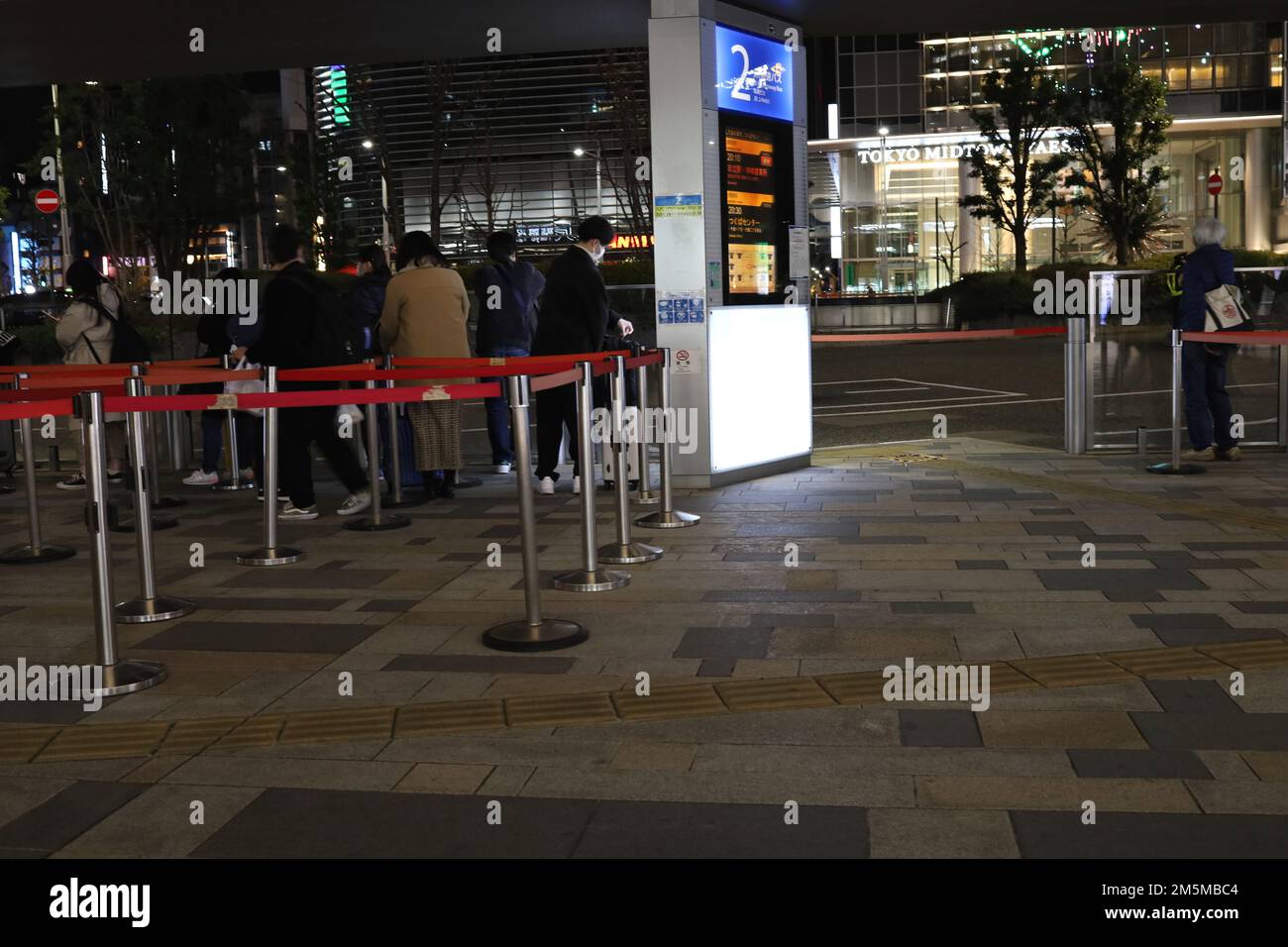 Chiyoda Ward, Tokyo, Japan, December 2022.People waiting for a highway ...