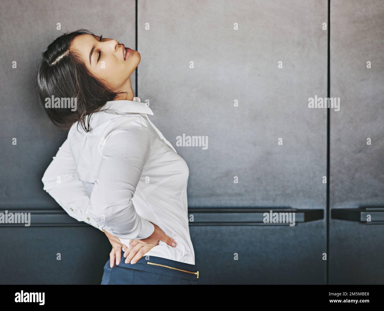Woman holding lower back hi-res stock photography and images - Alamy