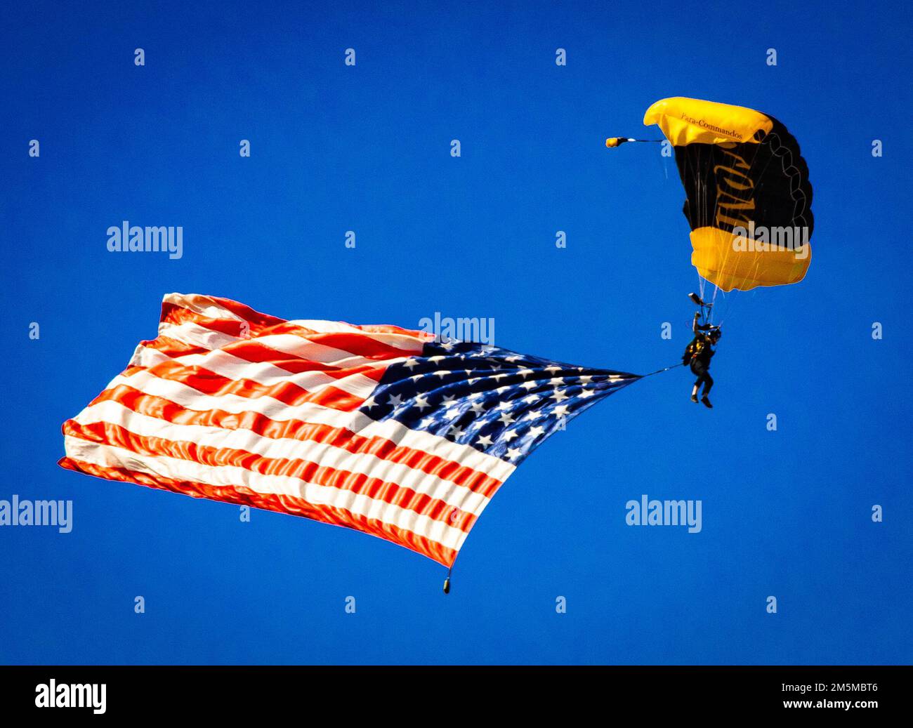 Old Glory flutters in the clear, blue sky above Tampa Bay as a member ...