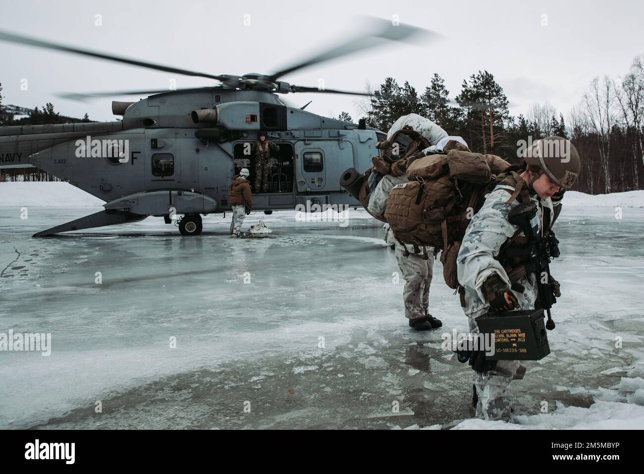 U.S. Marines unload gear from a British Royal Navy Merlin MK4 during ...