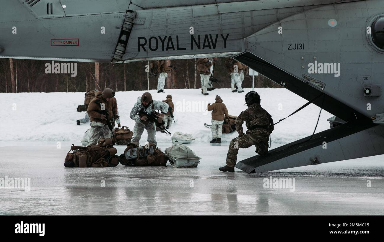 U.S. Marines unload gear from a British Royal Navy Merlin MK4 during ...