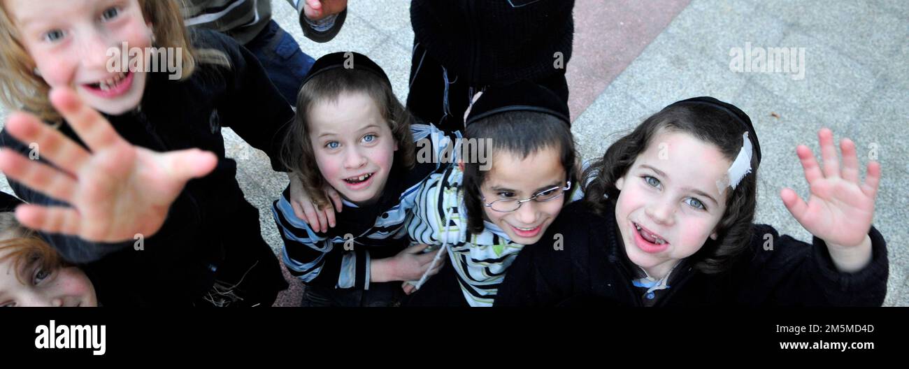 Cheerful & happy. Orthodox Jewish boys having fun in the courtyard of ...