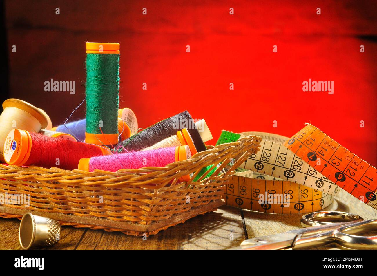 Sewing material with red background Stock Photo - Alamy