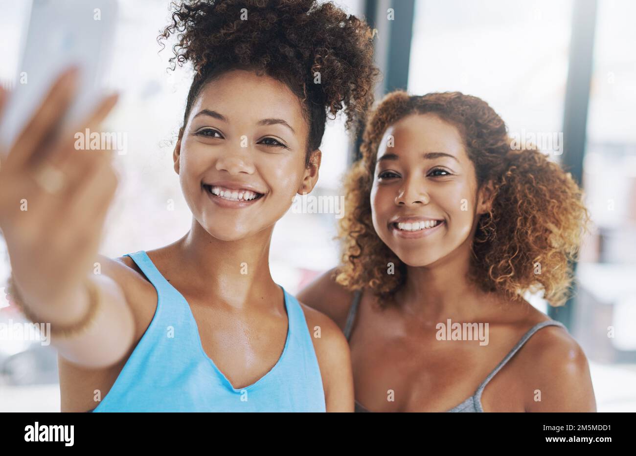 Lets snap a couple selfies. two young women taking a selfie after yoga ...