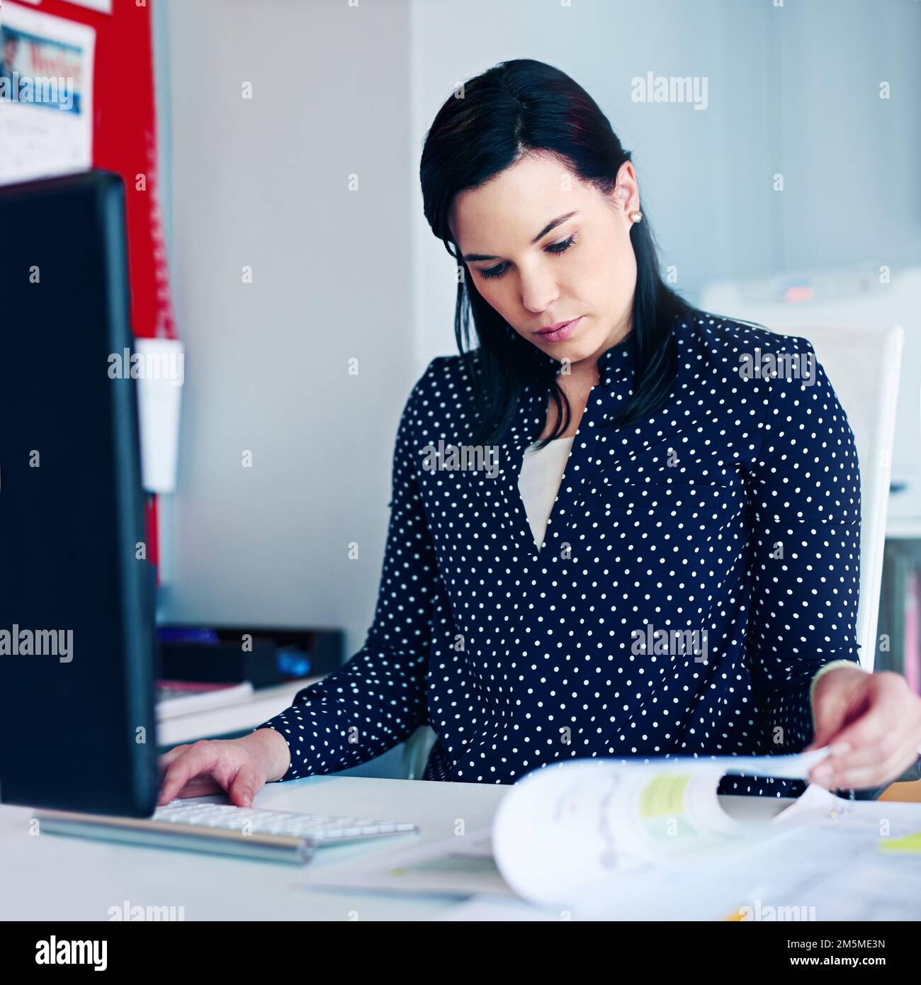 Always read the fine print. a young businesswoman working at her desk ...