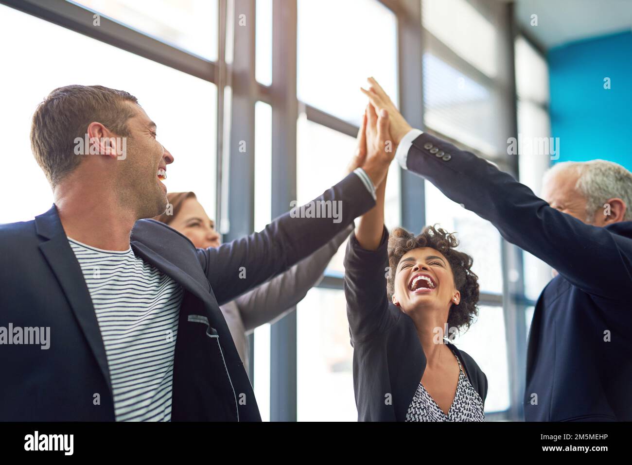 Powered by professional positivity. a group of colleagues giving each ...