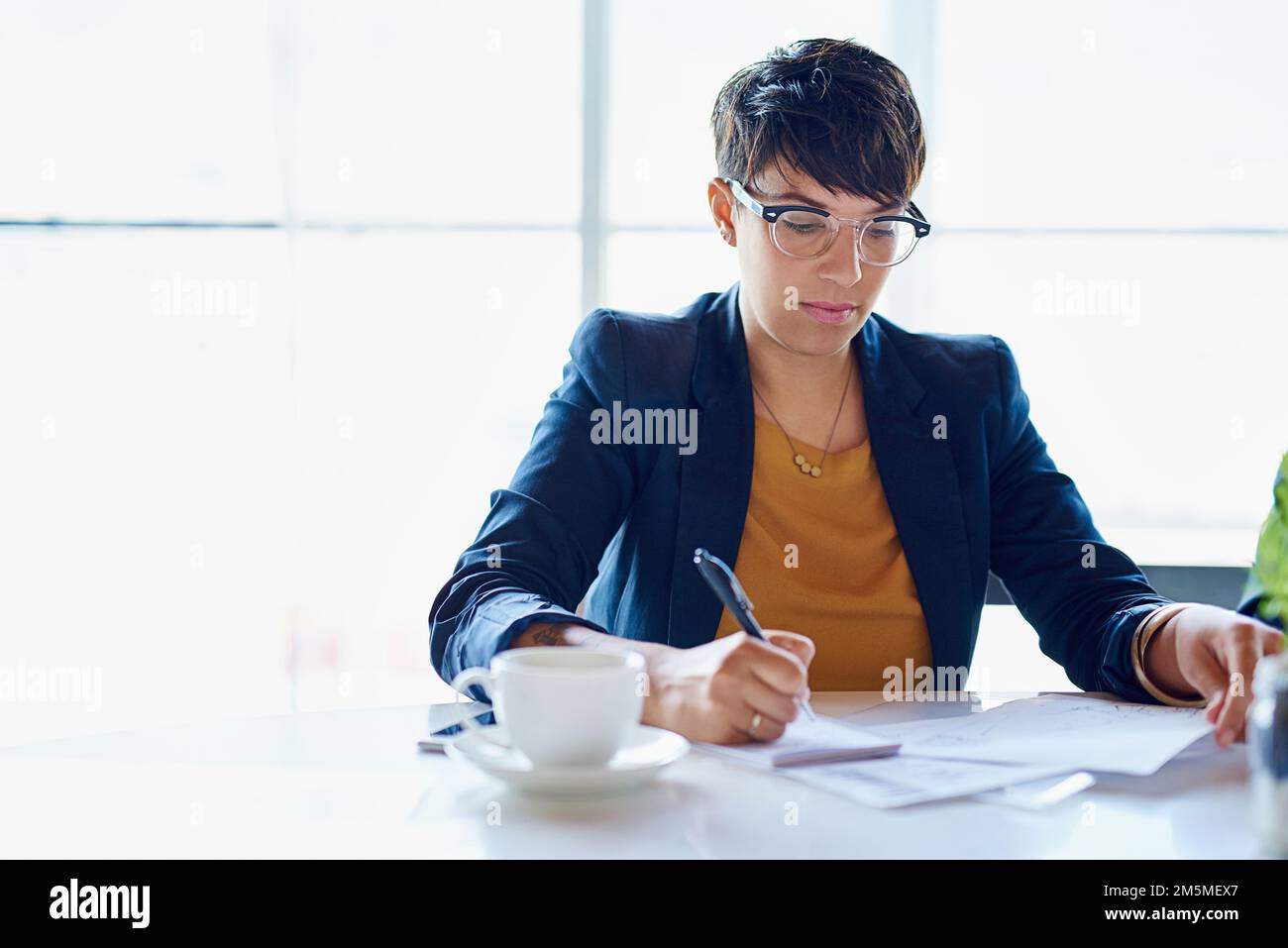 Success is dependent on effort. a businesswoman working on paperwork in ...