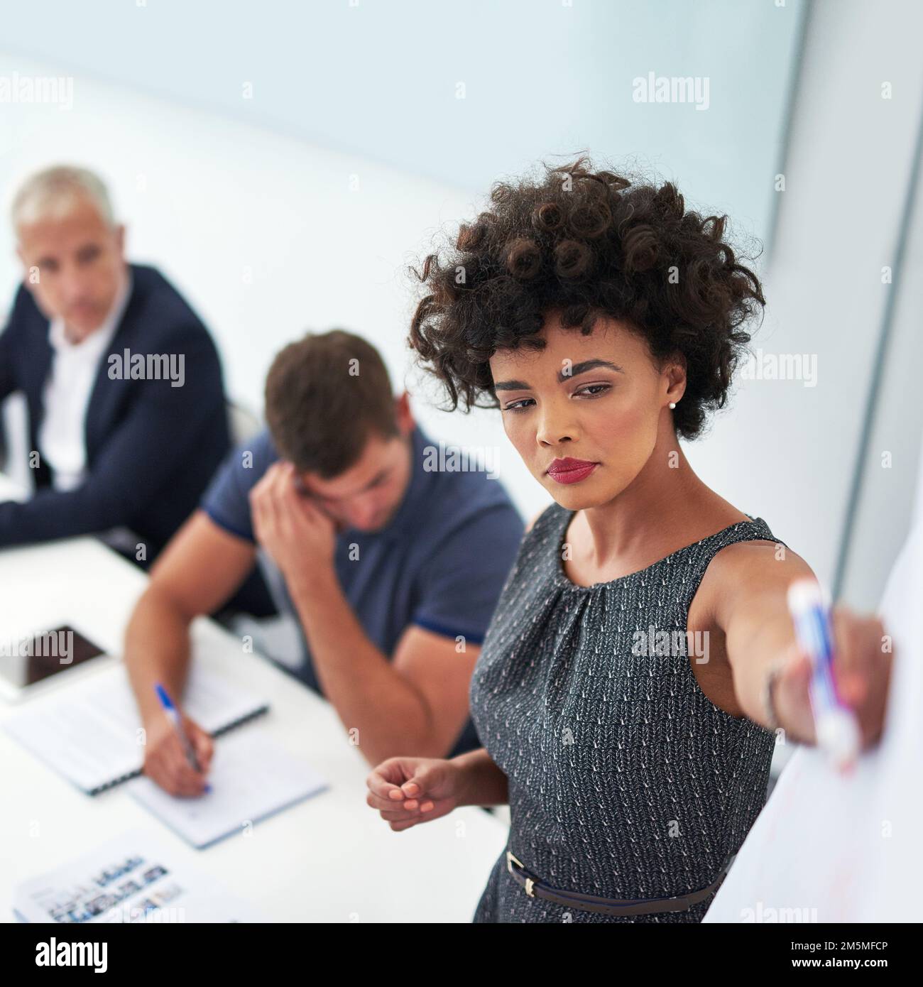 Charting their success. a young businesswoman giving a presentation in ...