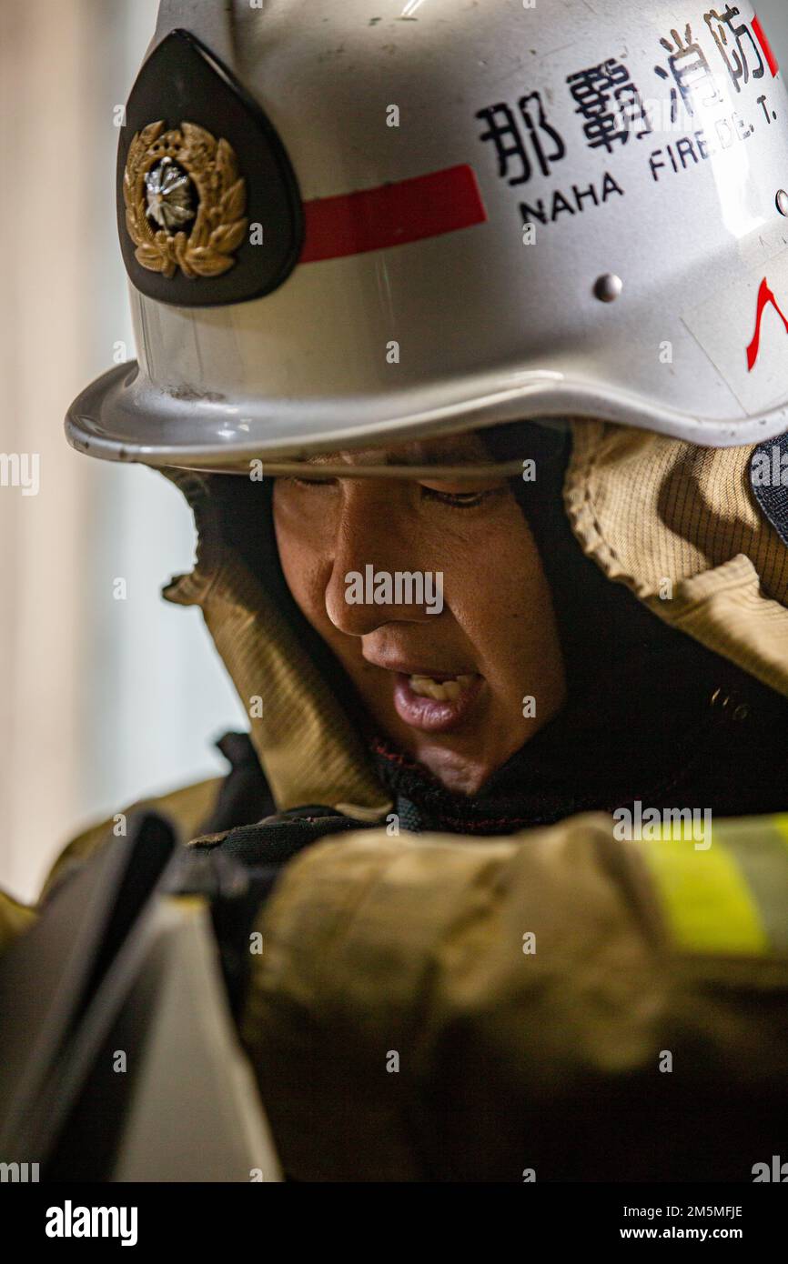 A firefighter with the Naha City Fire Department establishes radio ...