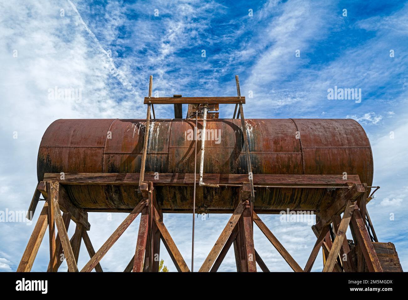 Old rusty oil tank raised on scaffolding Stock Photo - Alamy