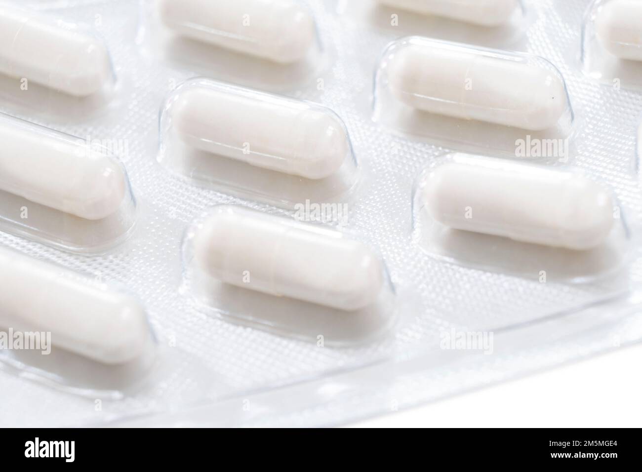 Macro shot pile of tablets pill in silver blister packaging isolated on ...