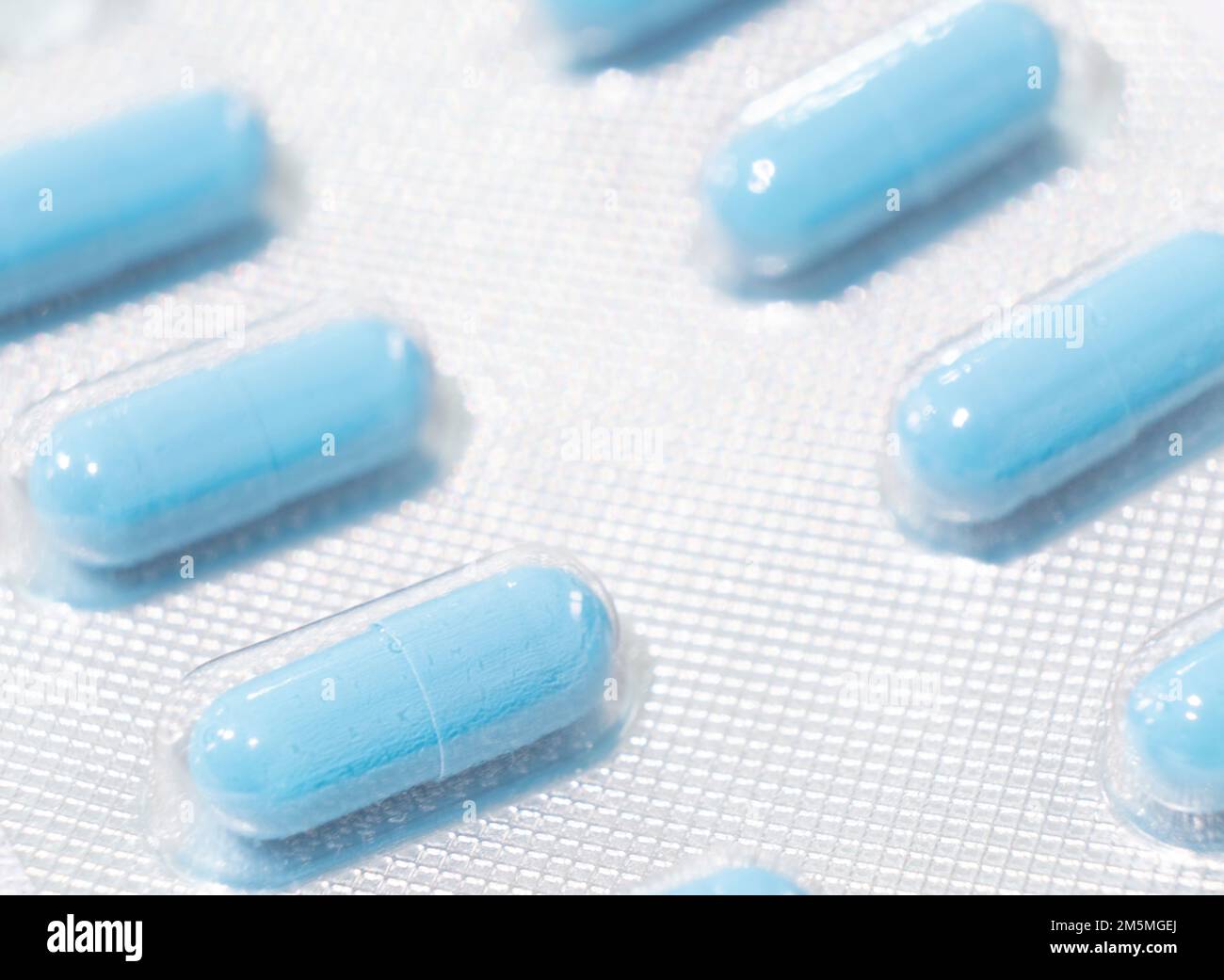 Macro shot pile of tablets pill in silver blister packaging isolated on ...