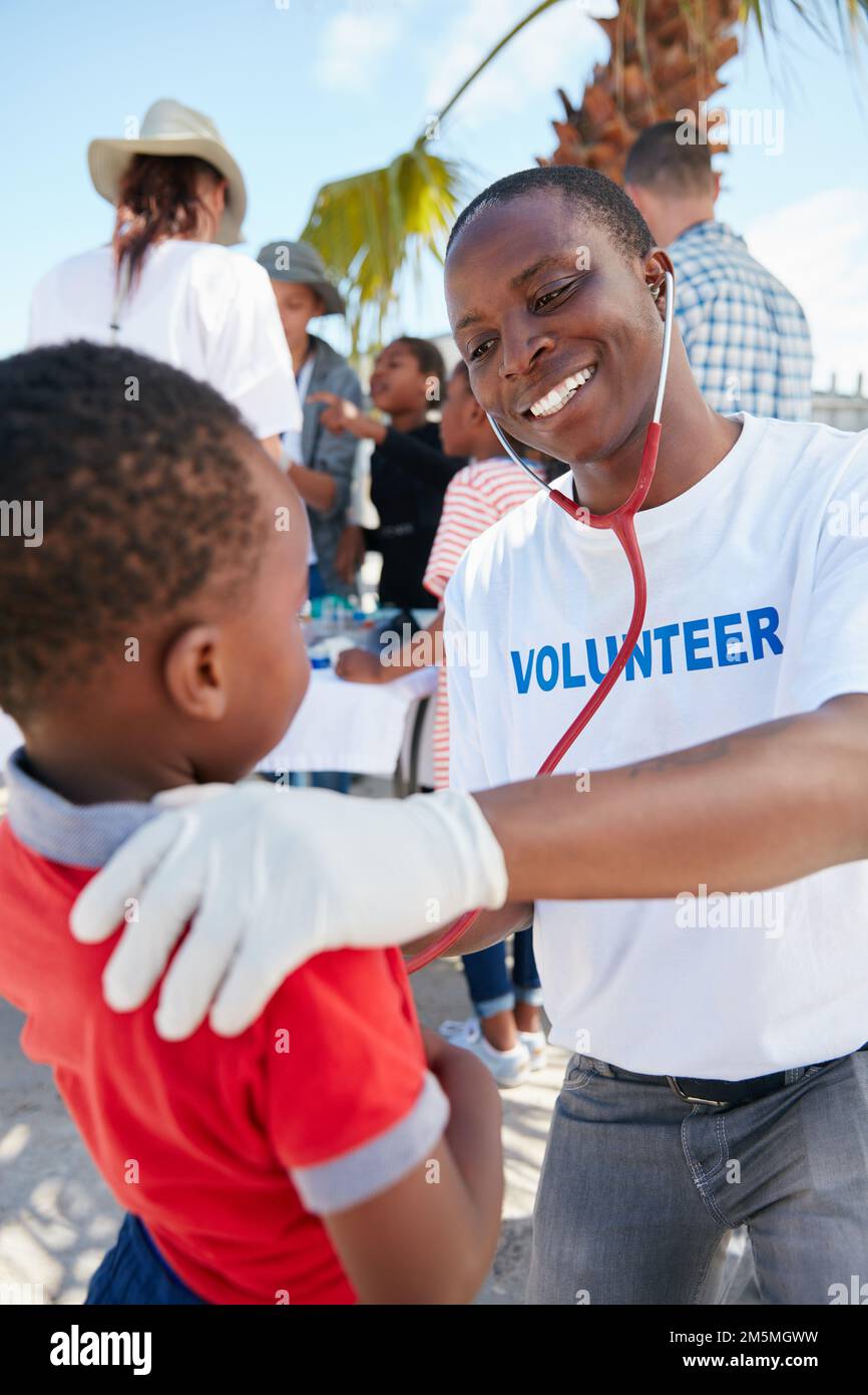 What a strong heart you have. a volunteer doctor examining a young ...