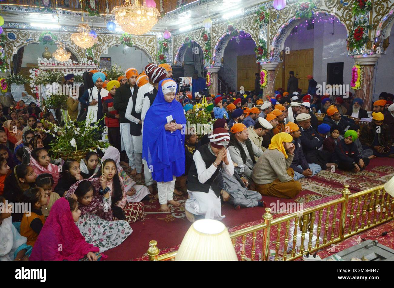 Peshawar, Pakistan. 28th Dec, 2022. Sikh devotees take part in a ...